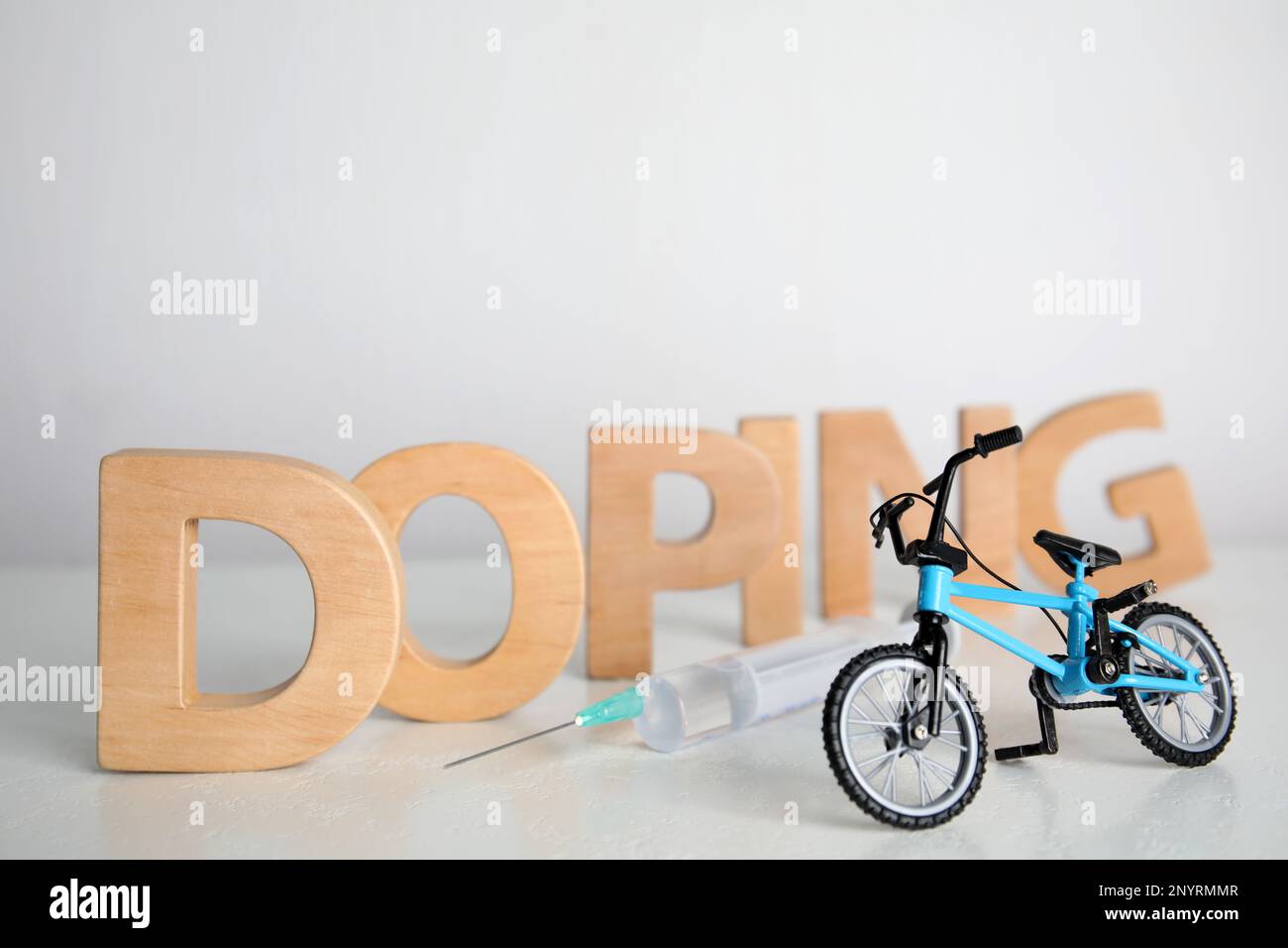 Word Doping, syringe and bicycle model on light background Stock Photo ...