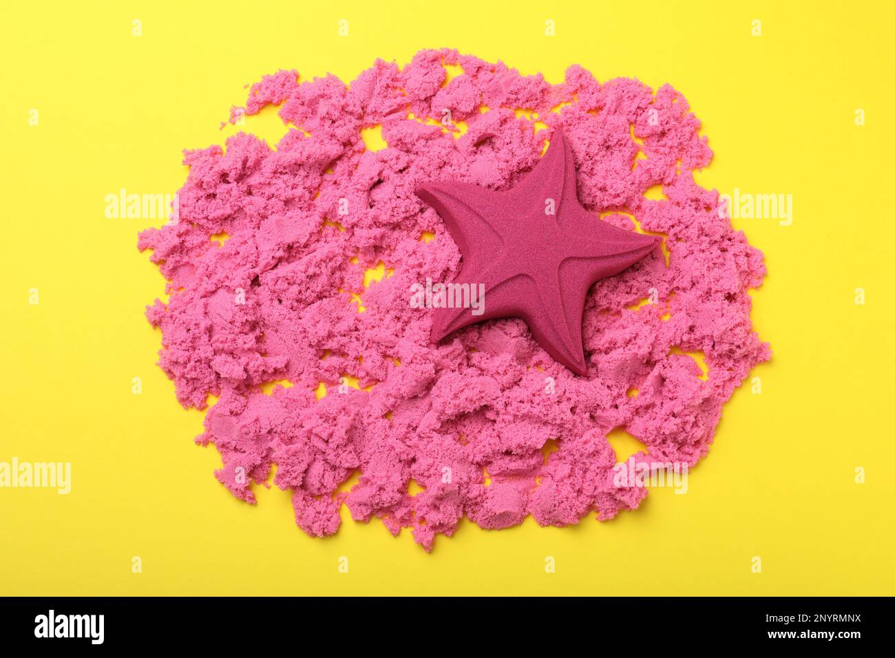 Star made of kinetic sand on yellow background, flat lay Stock Photo ...