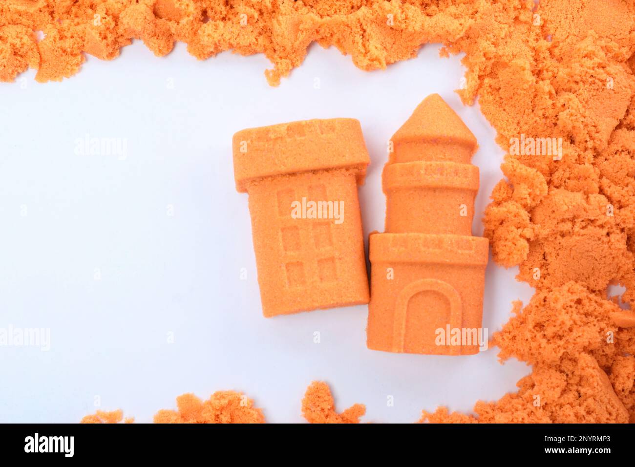Castle and tower made of kinetic sand on white background, top view ...