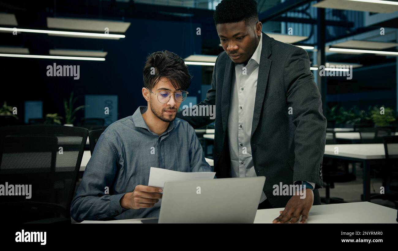 Male African boss businessman mentor teaching indian man trainee new ...