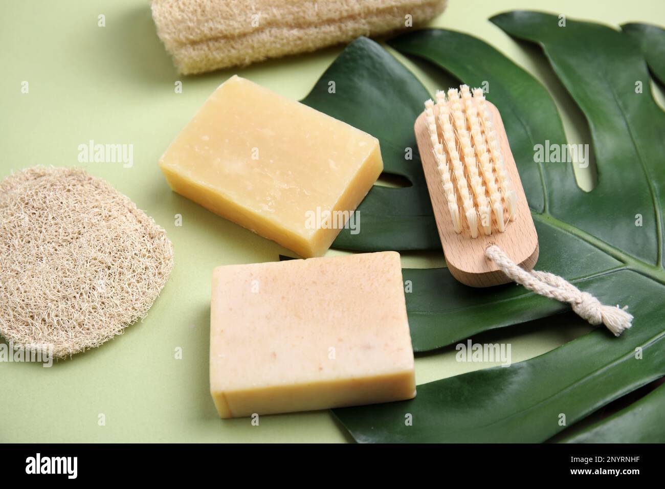 Eco friendly personal care products and leaf on light green background ...