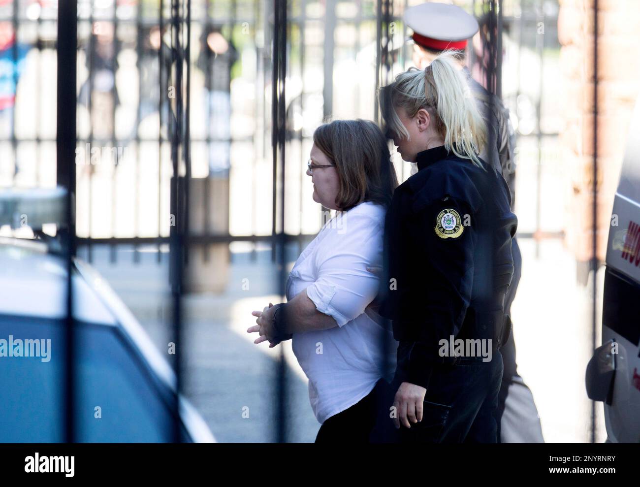 Elizabeth Wettlaufer is escorted into the Provincial courthouse in ...