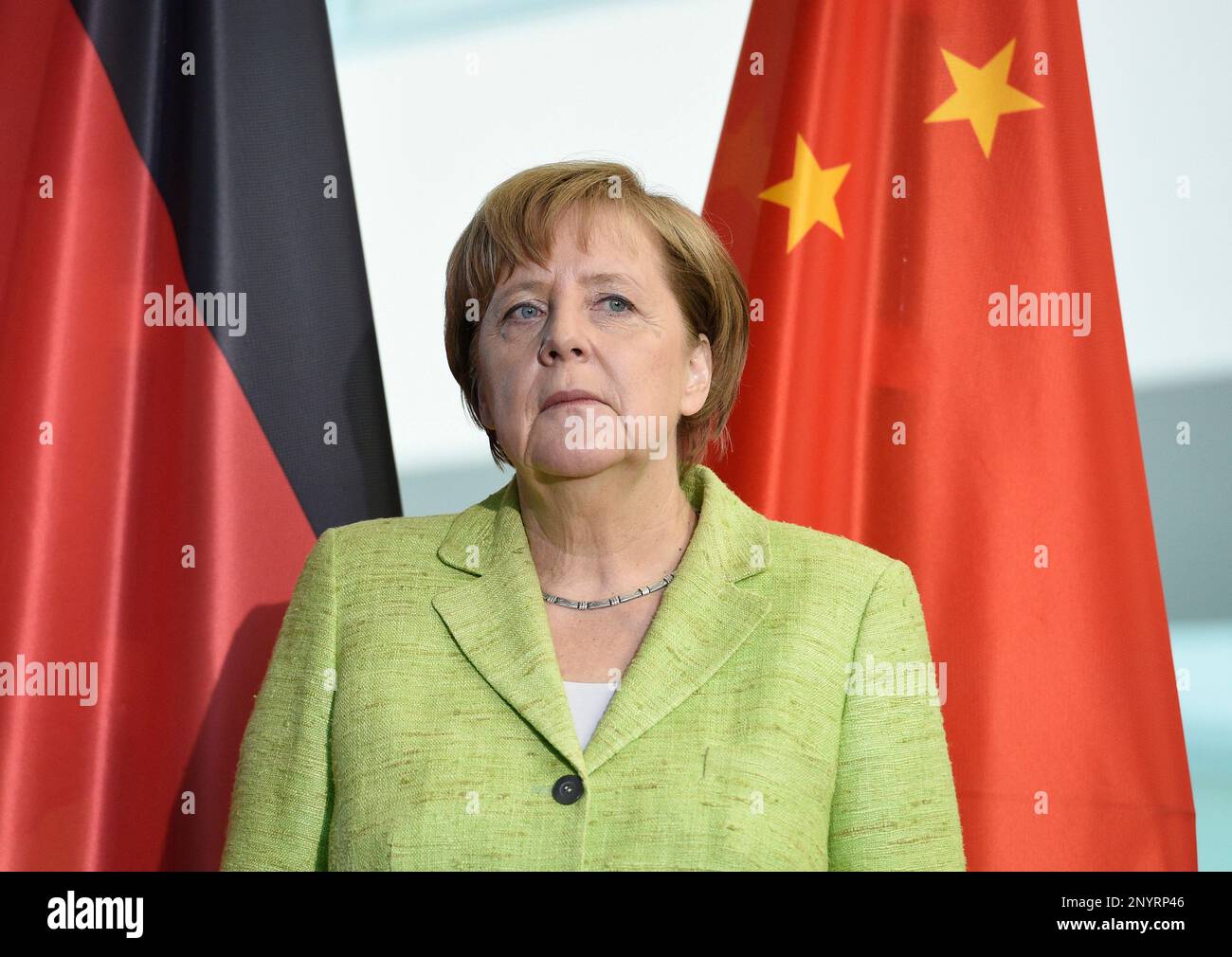German Chancellor Angela Merkel pictured between a German, left, and a ...