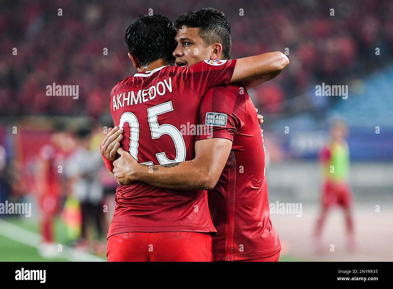 Brazilian football player Elkeson, right, and his teammate Uzbek soccer player Odil Ahmedov of ...