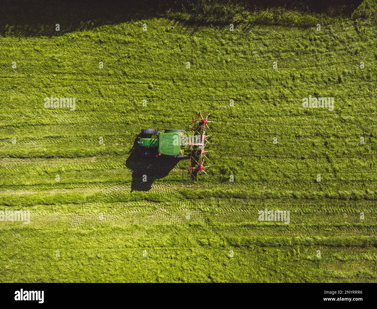 Top down view, directly above a tractor mowing a grass field Stock ...