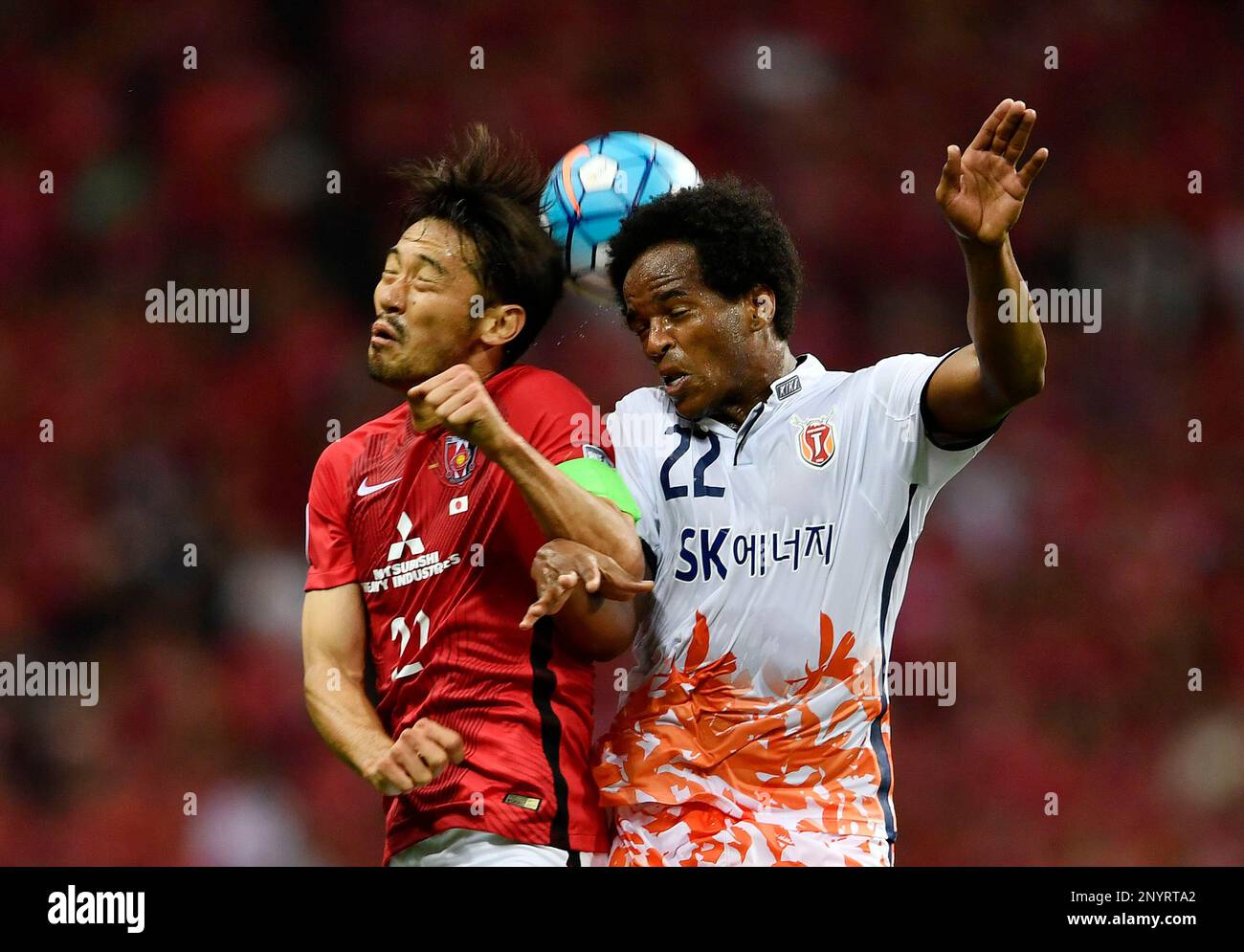 Yuki Abe of Japan's Urawa Red Diamonds, left, heads the ball against ...