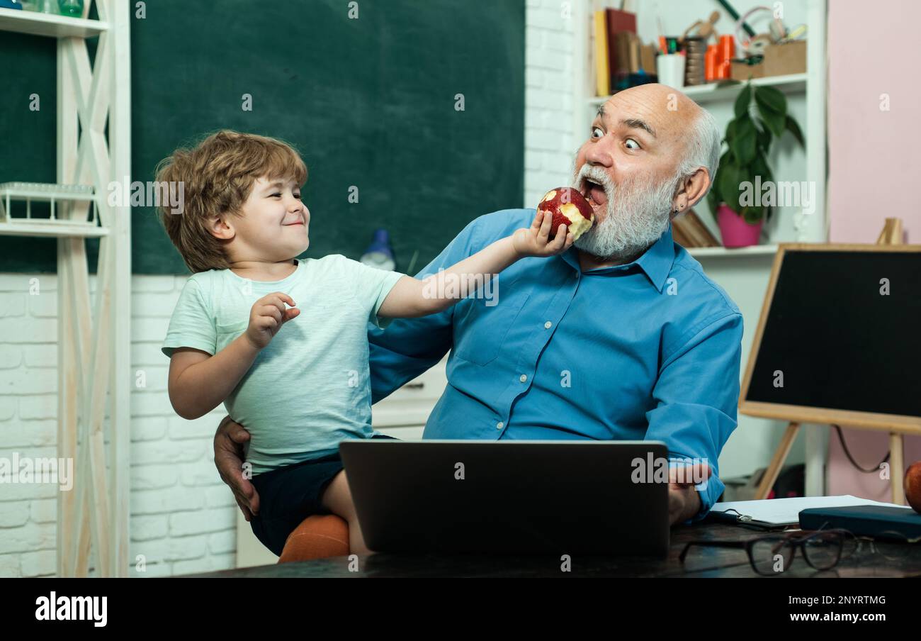 Teacher and pupil learning together in school. Family generation and relations concept. Happy ...