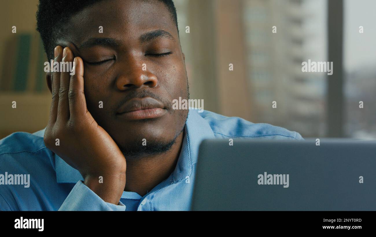 Sleepy overworked tired african american man employee manager ...