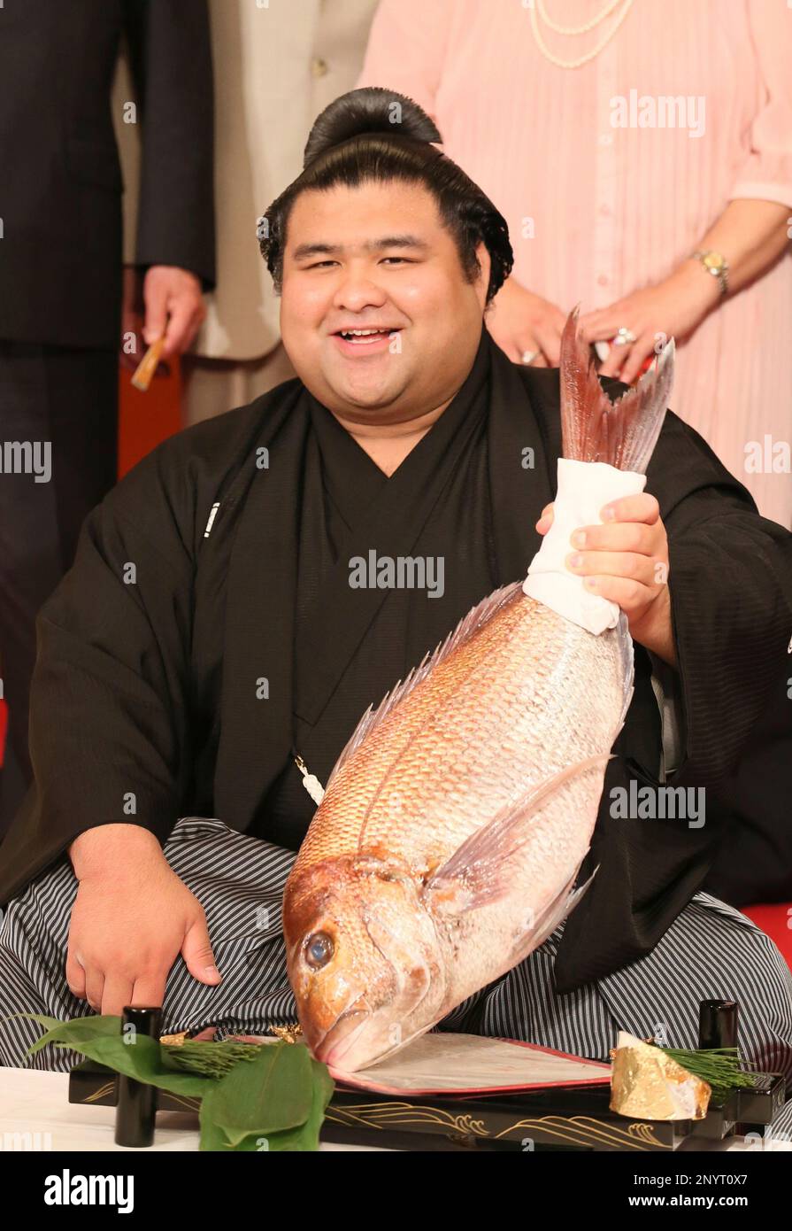 Sumo wrestler Takayasu poses holding a sea bream after officially being ...