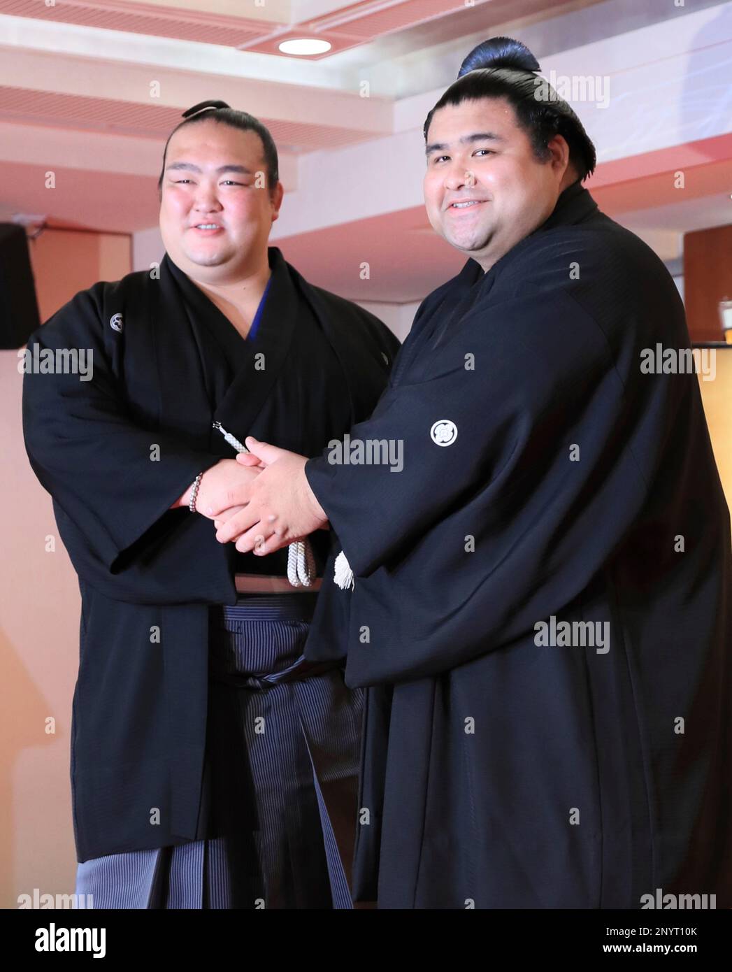 Sumo wrestler Takayasu (R) , shakes hands with yokozuna Kisensato after ...