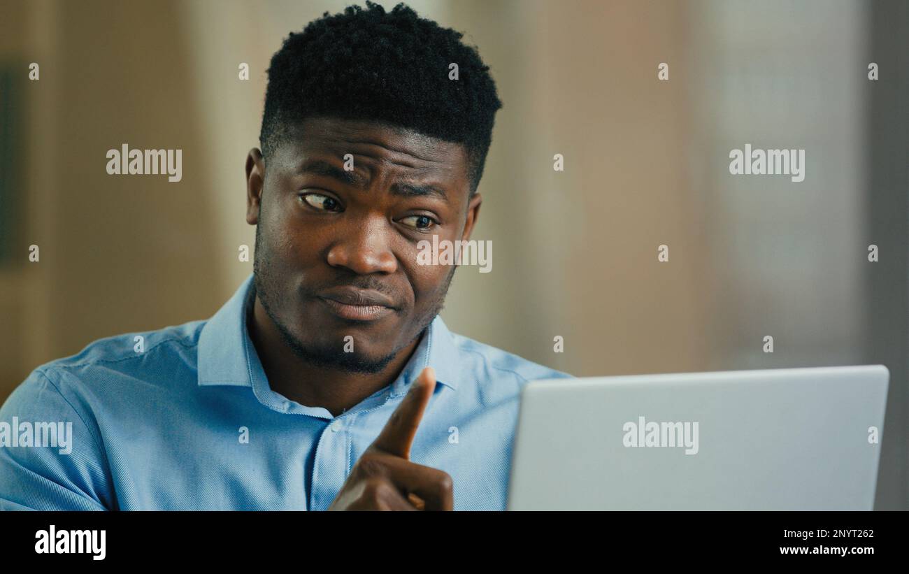 Angry annoyed man african businessman boss talk in video conference use ...