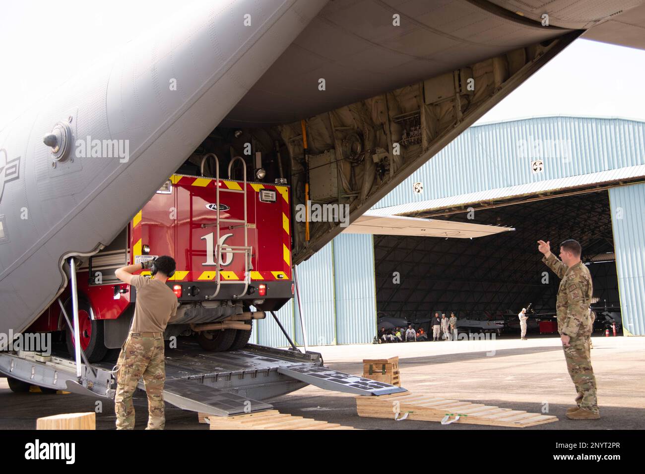 U.S. Airmen unload a P-34 Rapid Intervention Vehicle from a C-130J ...