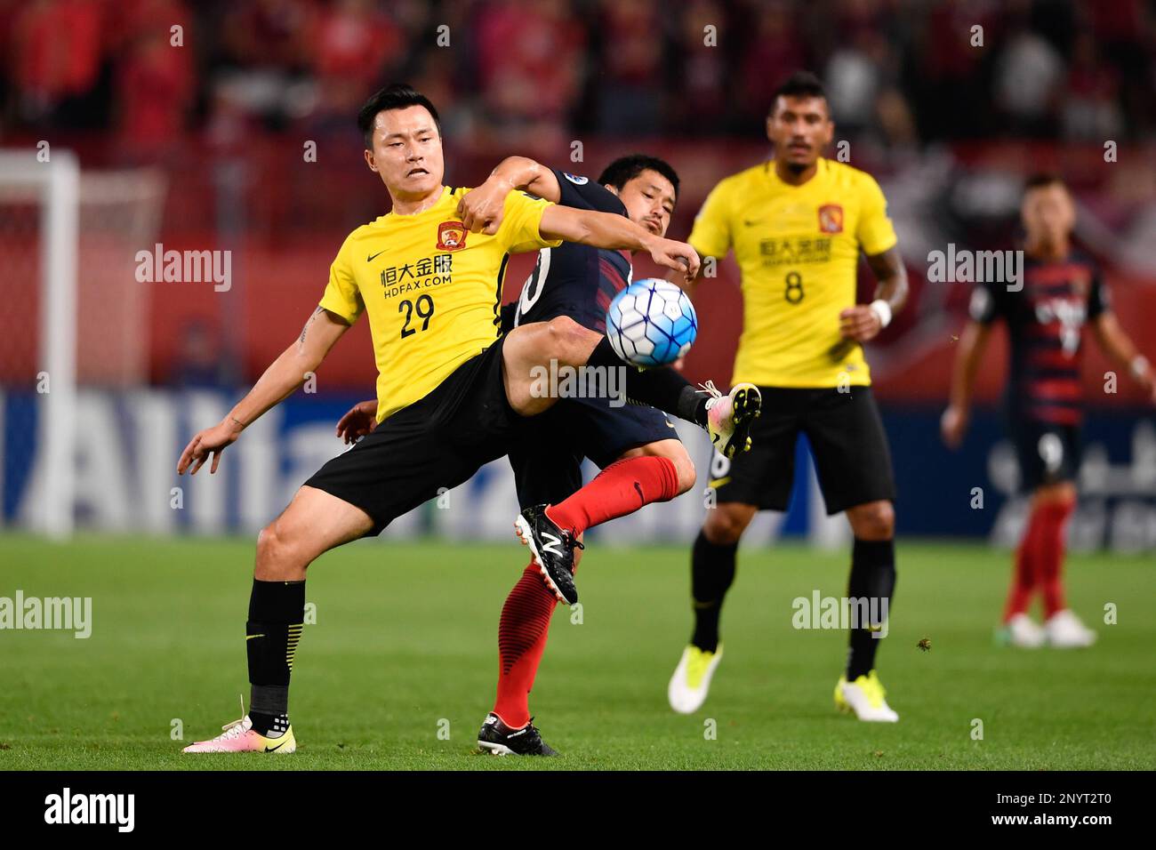 Gao Lin of China's Guangzhou Evergrande, left, challenges Mitsuo ...