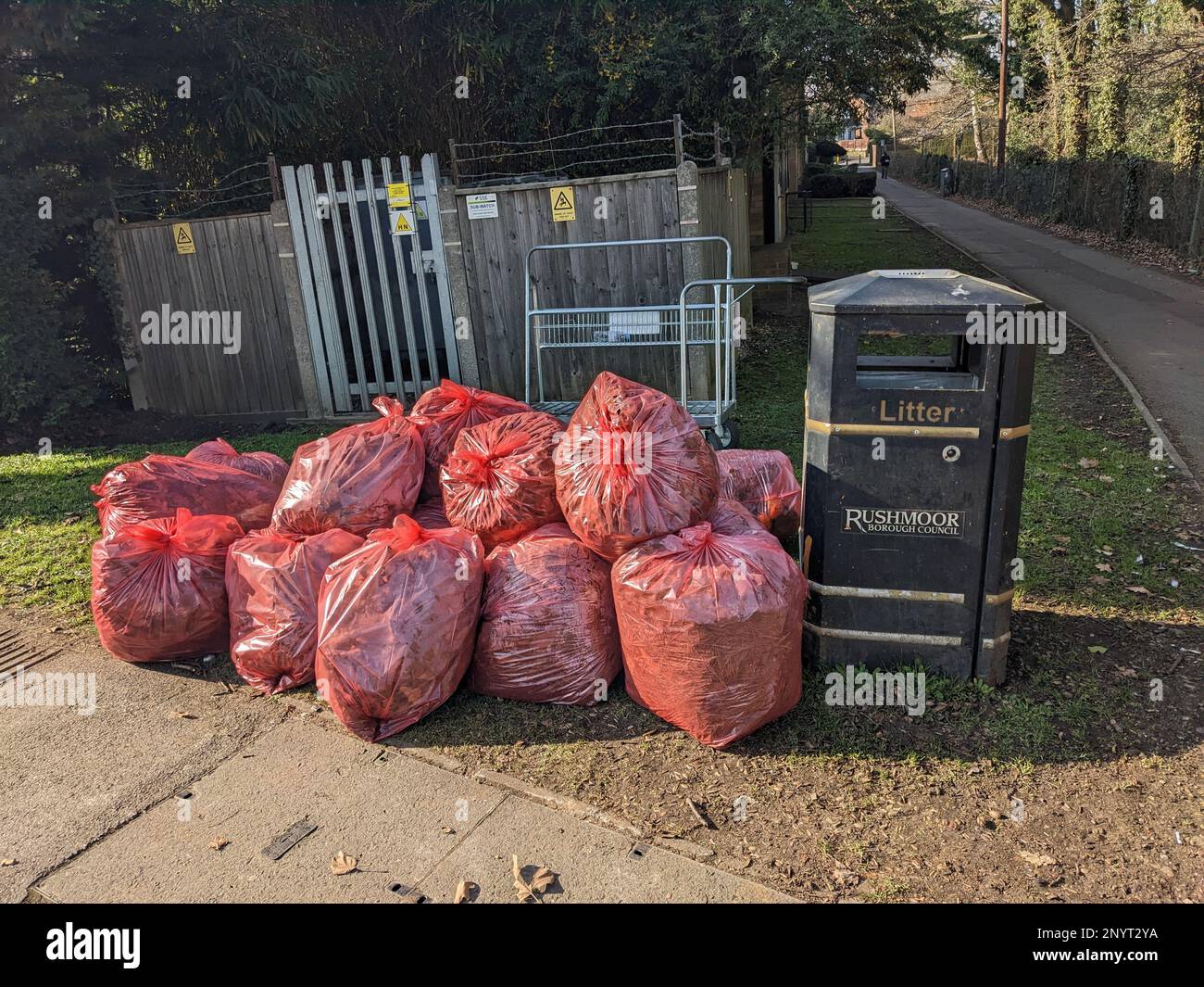 A Red Bin Bags Piling Up on A Street Corner Waiting to Be Collected ...