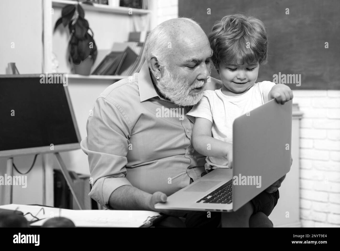 Concept of education and reading. Grandfather with grandson learning ...