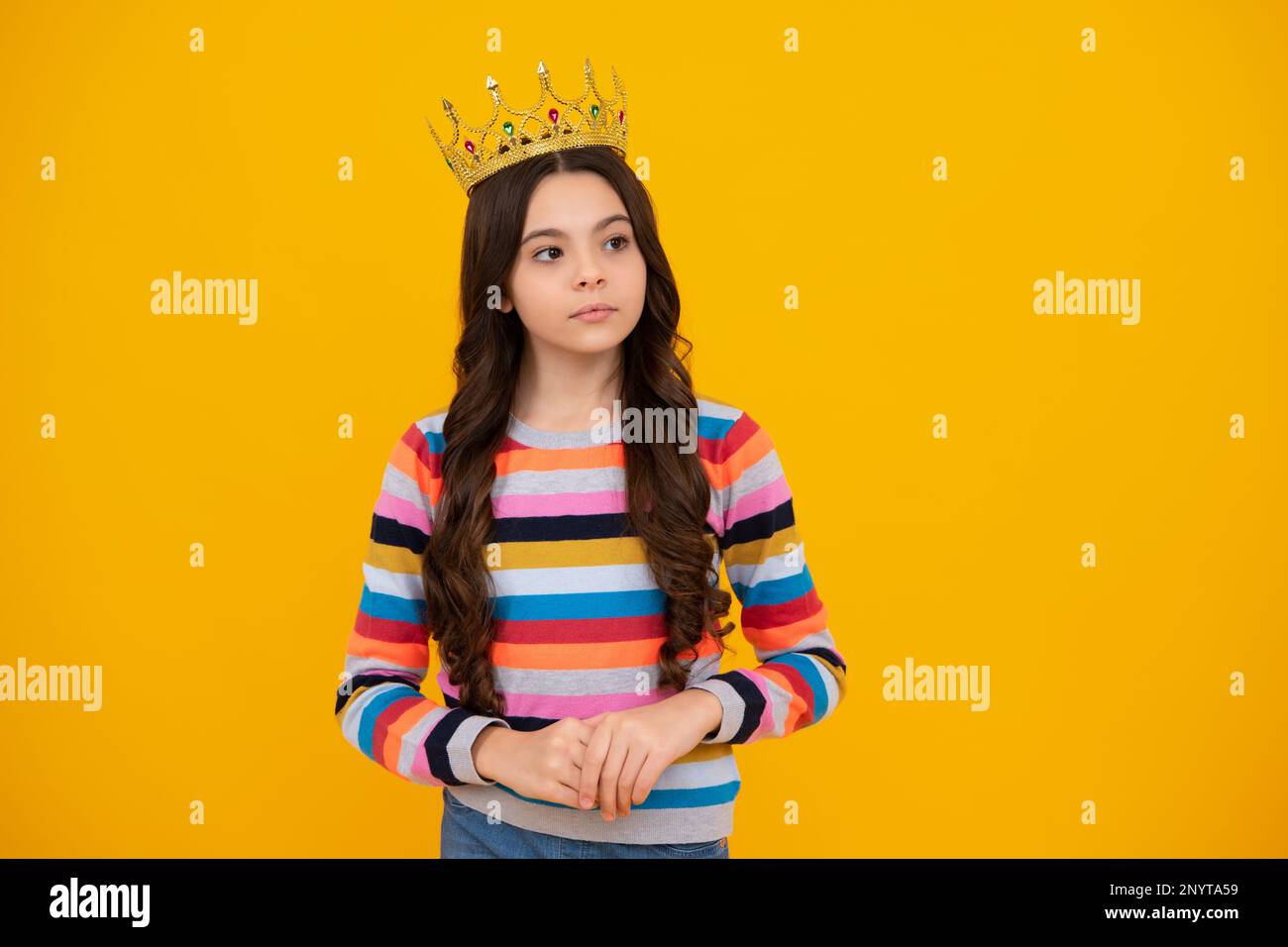 Little queen wearing golden crown. Teenage girl princess holding crown ...