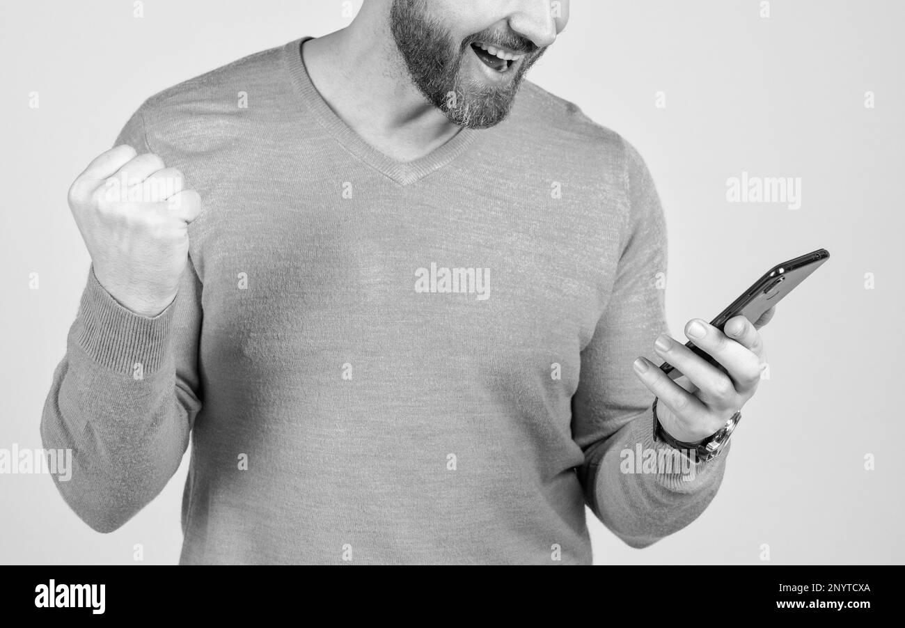 happy man with beard watching and reading smartphone, mobile device ...