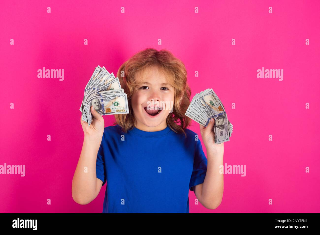 Money win, big luck. Studio portrait of child with money banknotes. Kid ...