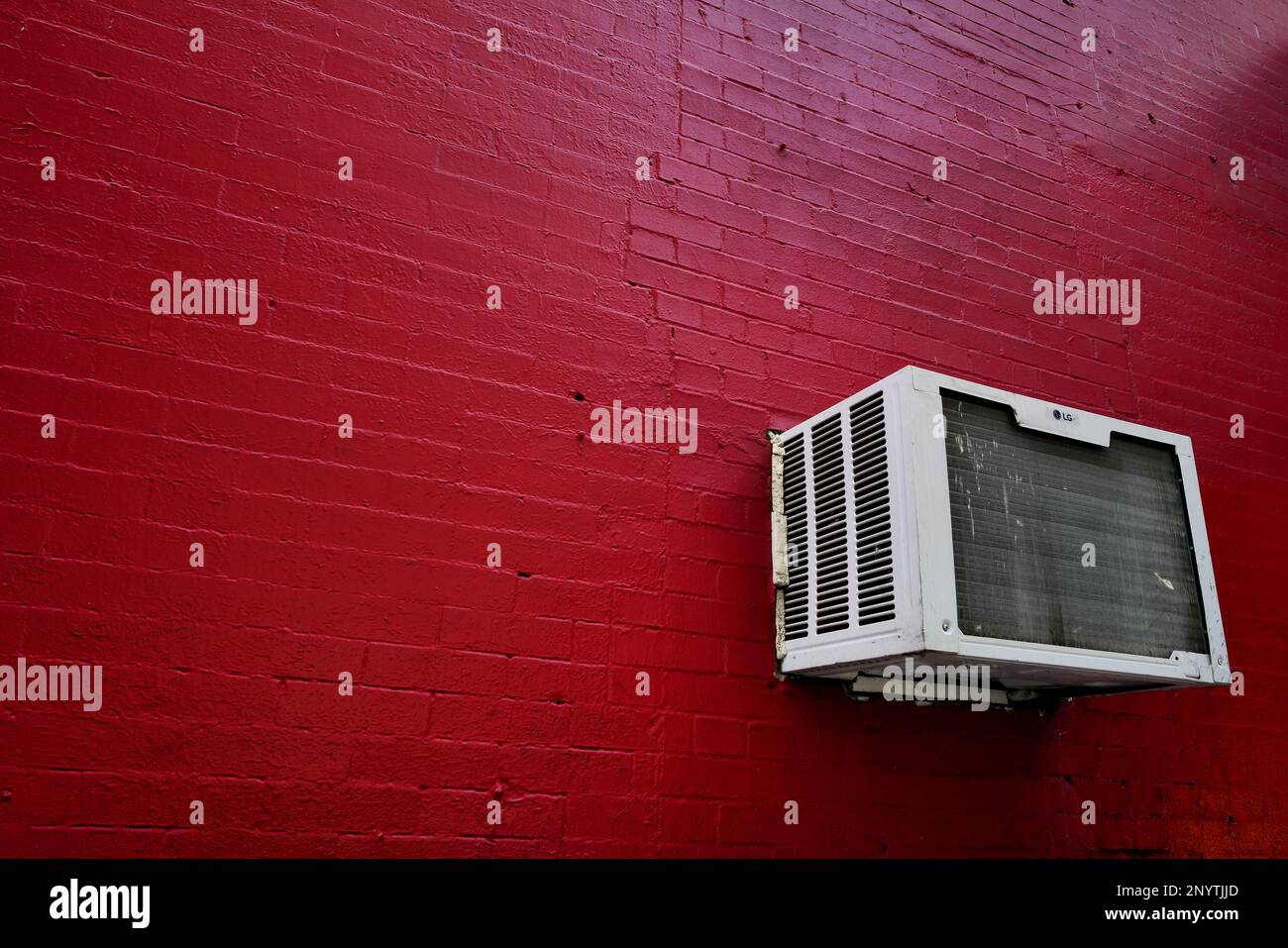 Air conditioner on a red wall in New York City Stock Photo - Alamy