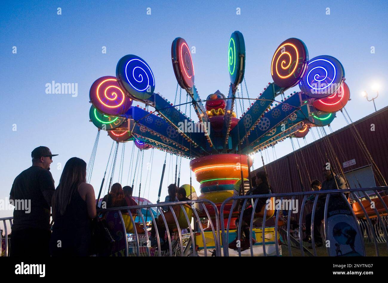 Bright night lights attract fair goers at the annual Porterville Fair ...