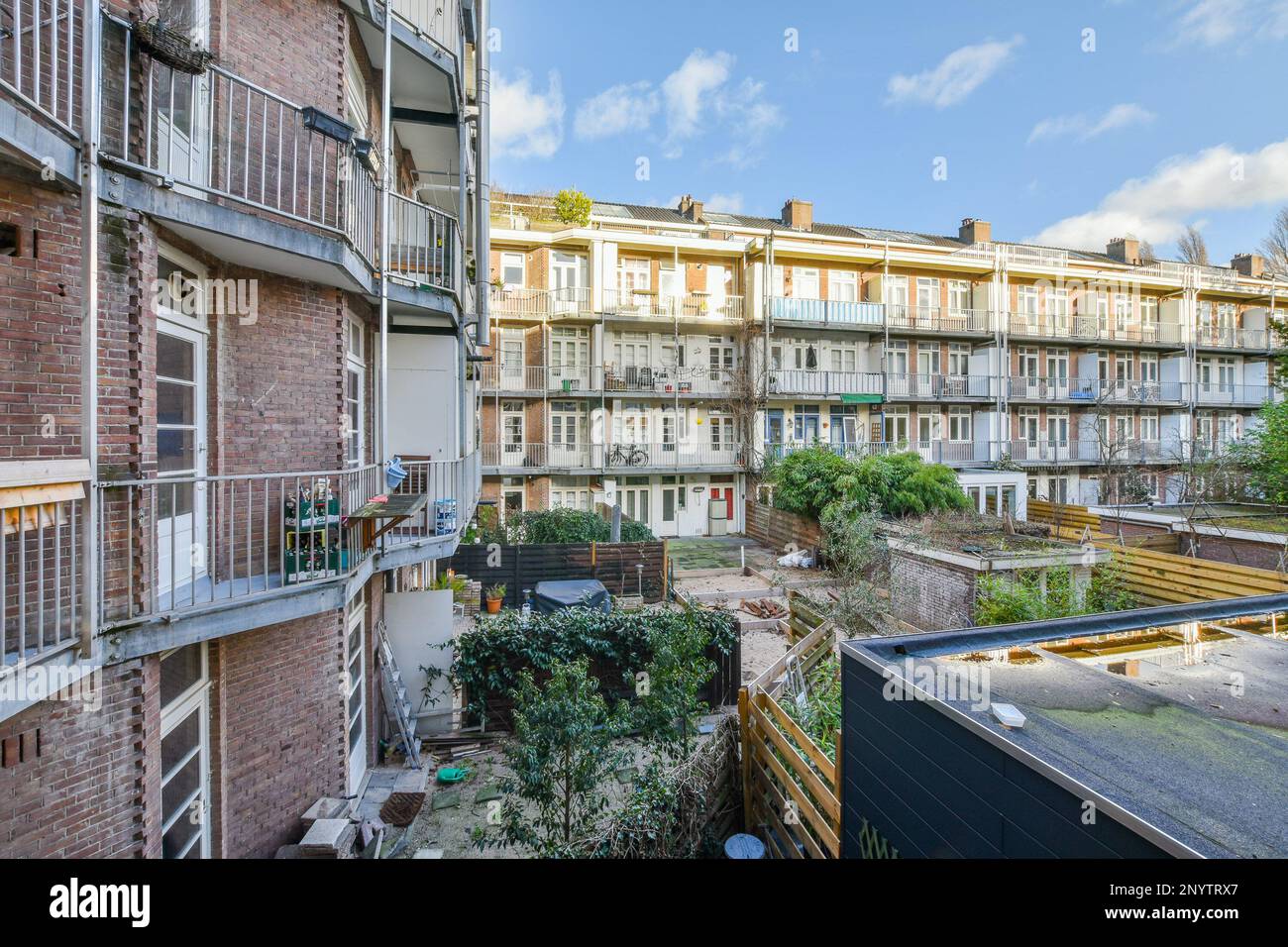 an outside area with some buildings and plants in the foregrounded area ...