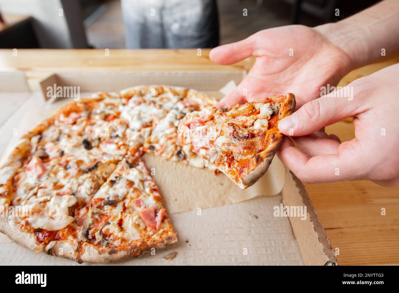 one people taking slices of pizza out of the box. fast delivery of food ...