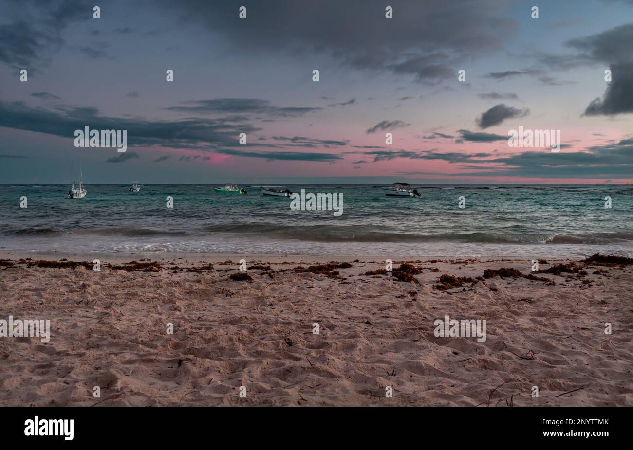 Fishing boats floating in turquoise waters of the Caribbean sea during ...