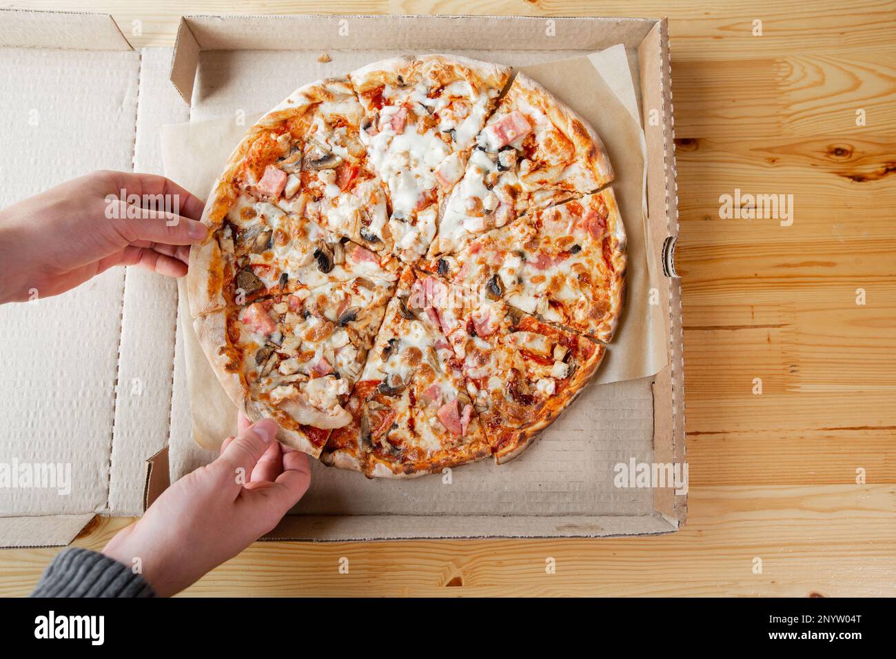 one people taking slices of pizza out of the box. fast delivery of food ...