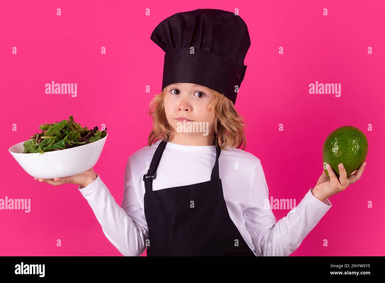Funny child cook with avocado and vegetable. Portrait of little child ...