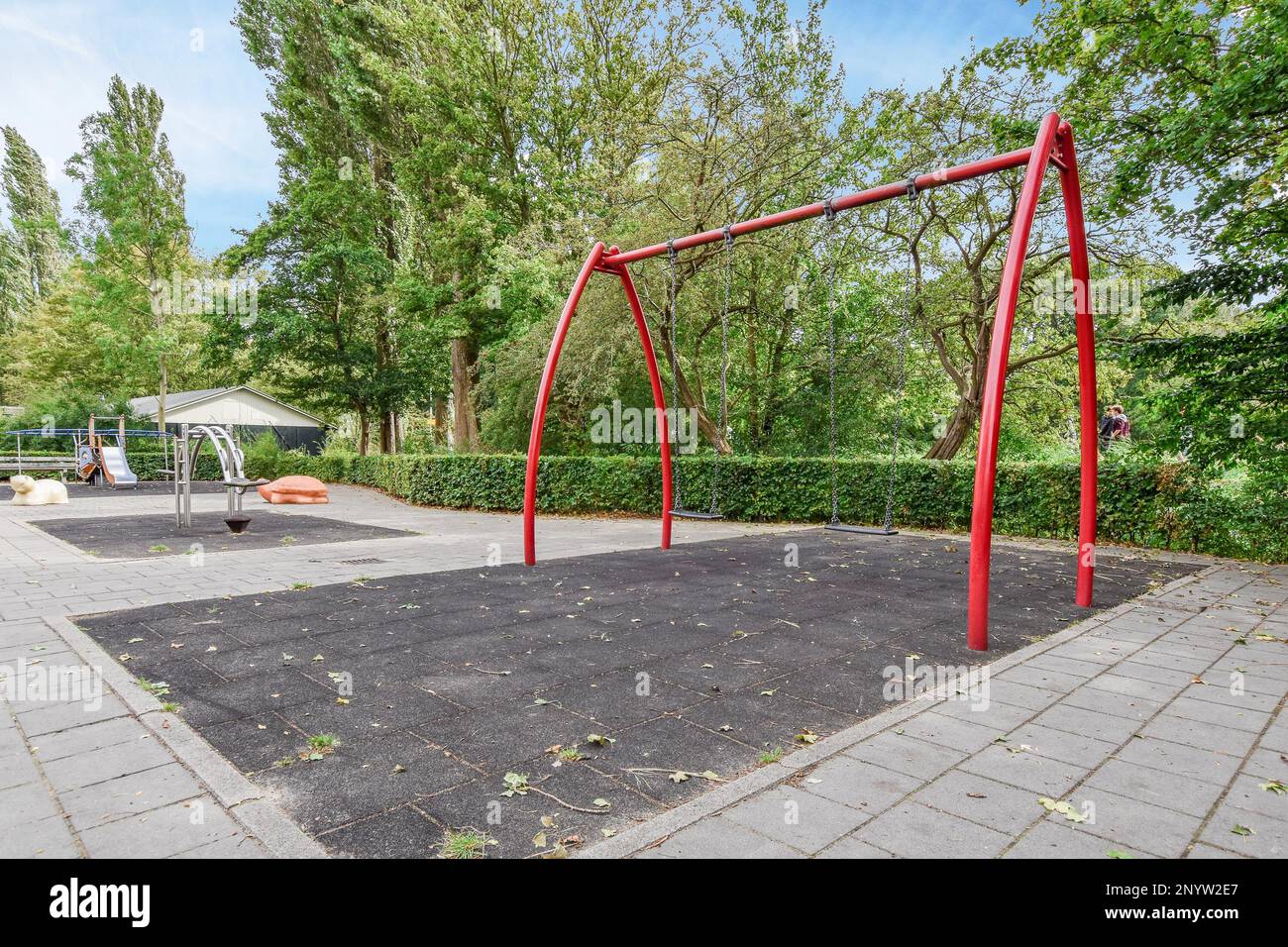 an empty playground area with swings and swing equipment on the ground ...