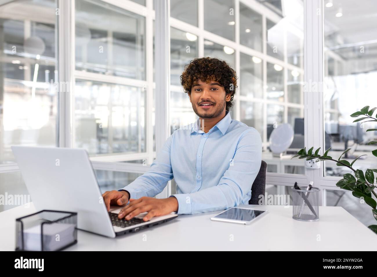 Portrait of young programmer inside office with laptop, indian man ...