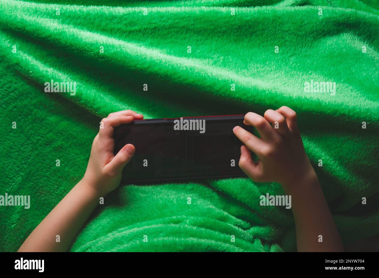 Phone in hands of child. Little boy playing mobile games on smartphone ...