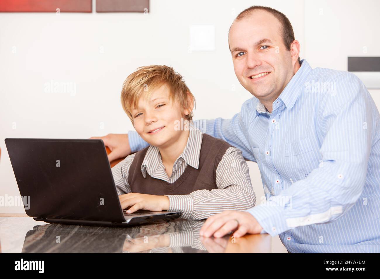 Family Life, Working Together. A father and son collaborating together ...