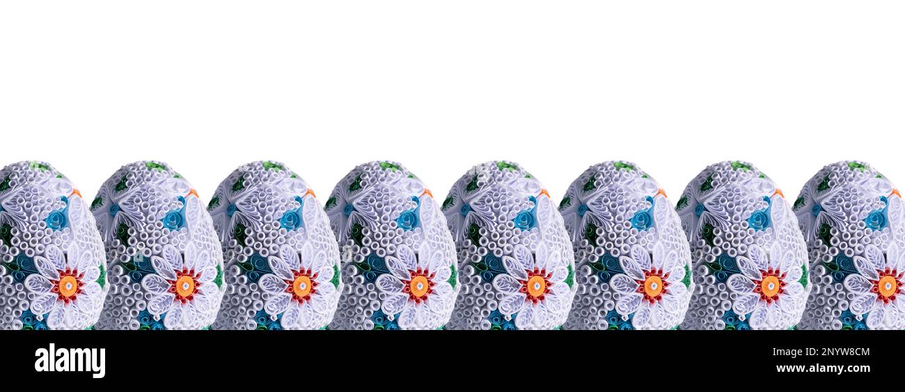 Many identical Easter eggs arranged at the bottom of the photo into a ...