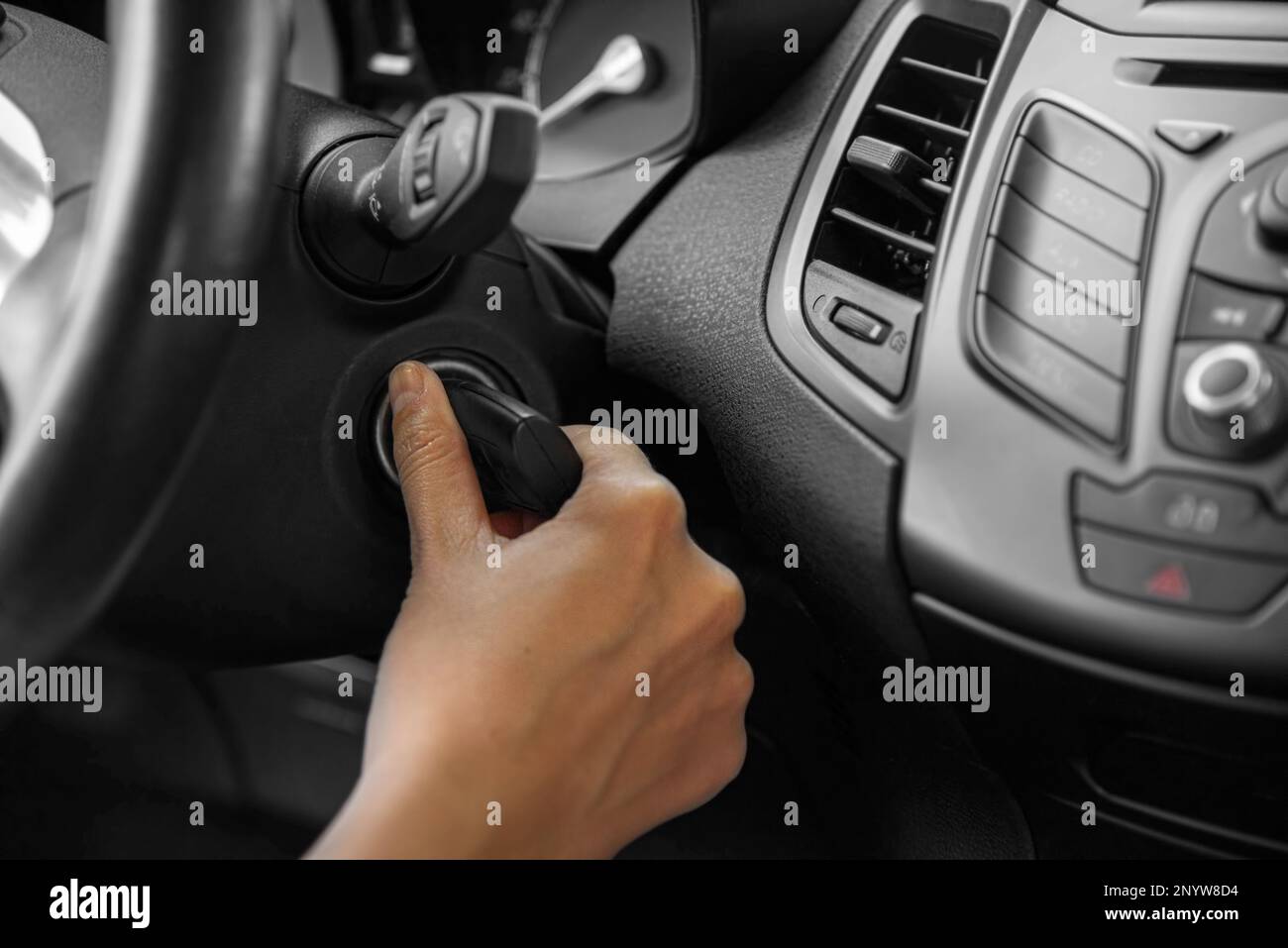 A woman's hand starts the car with a key Stock Photo - Alamy