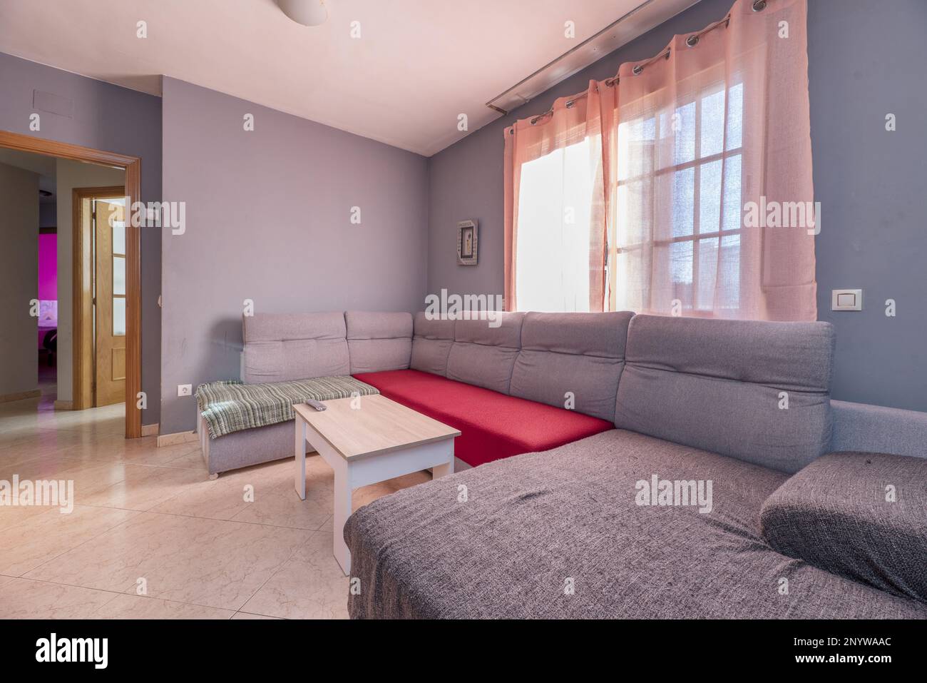 Furnished living room of a house with a stoneware floor and a perimeter ...