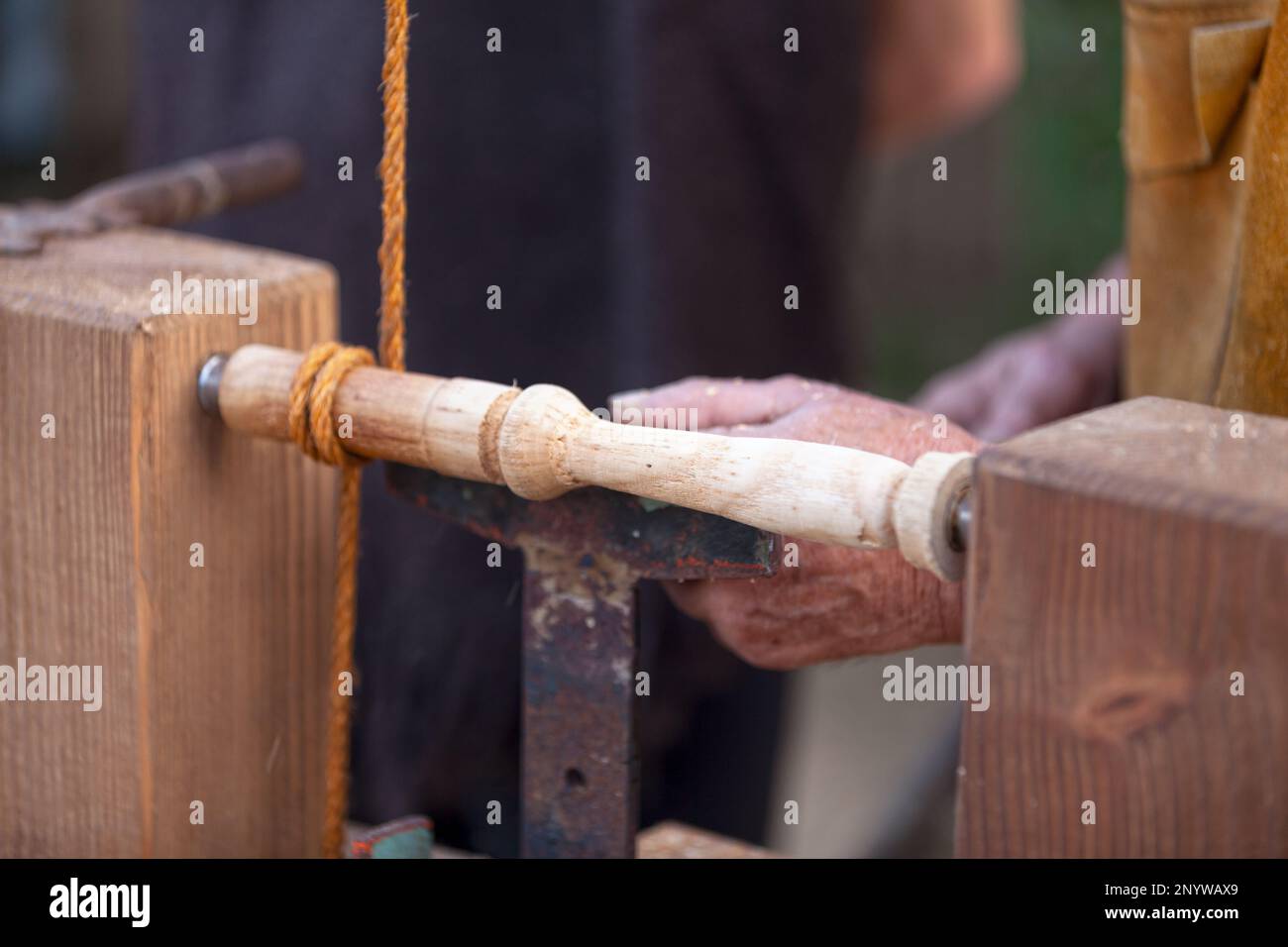 Medieval carpenter woodturning a chair leg with a gouge and a pole ...
