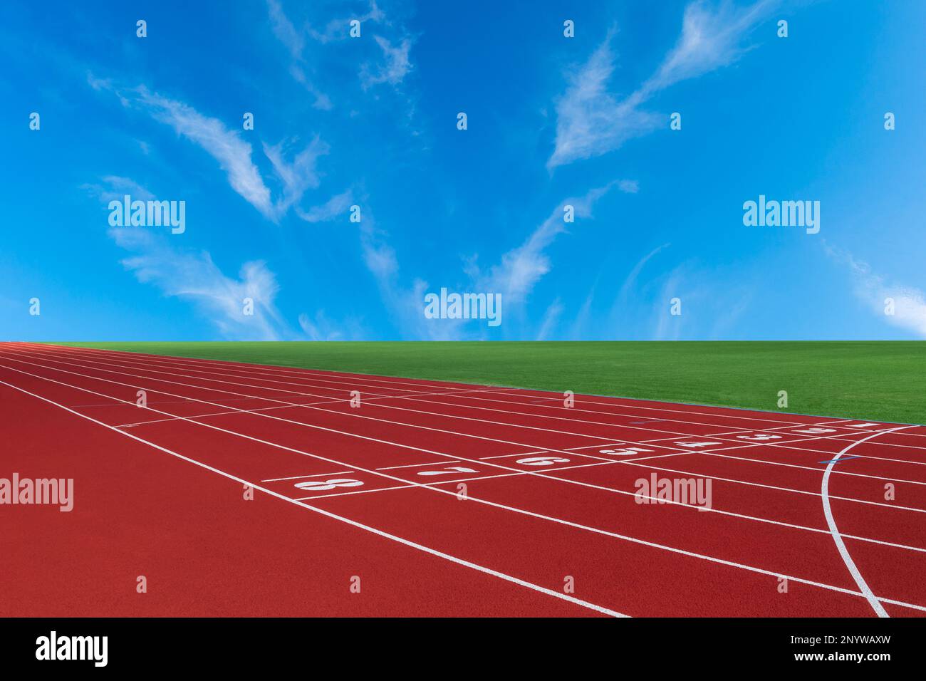 Red running track and blue sky in stadium. Sport theme background ...
