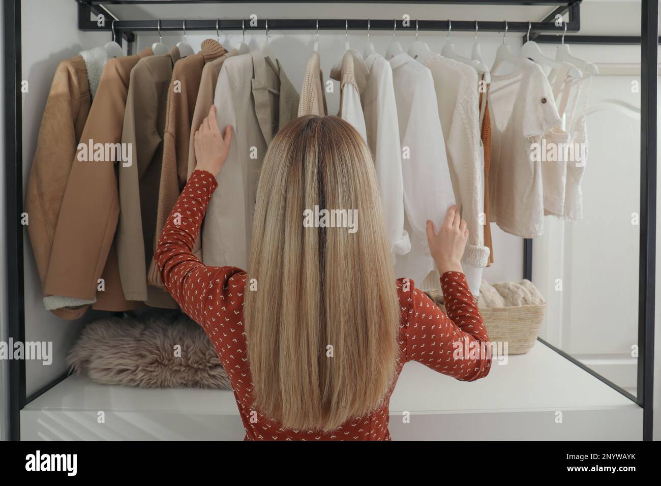 Young woman choosing outfit in dressing room, back view Stock Photo - Alamy
