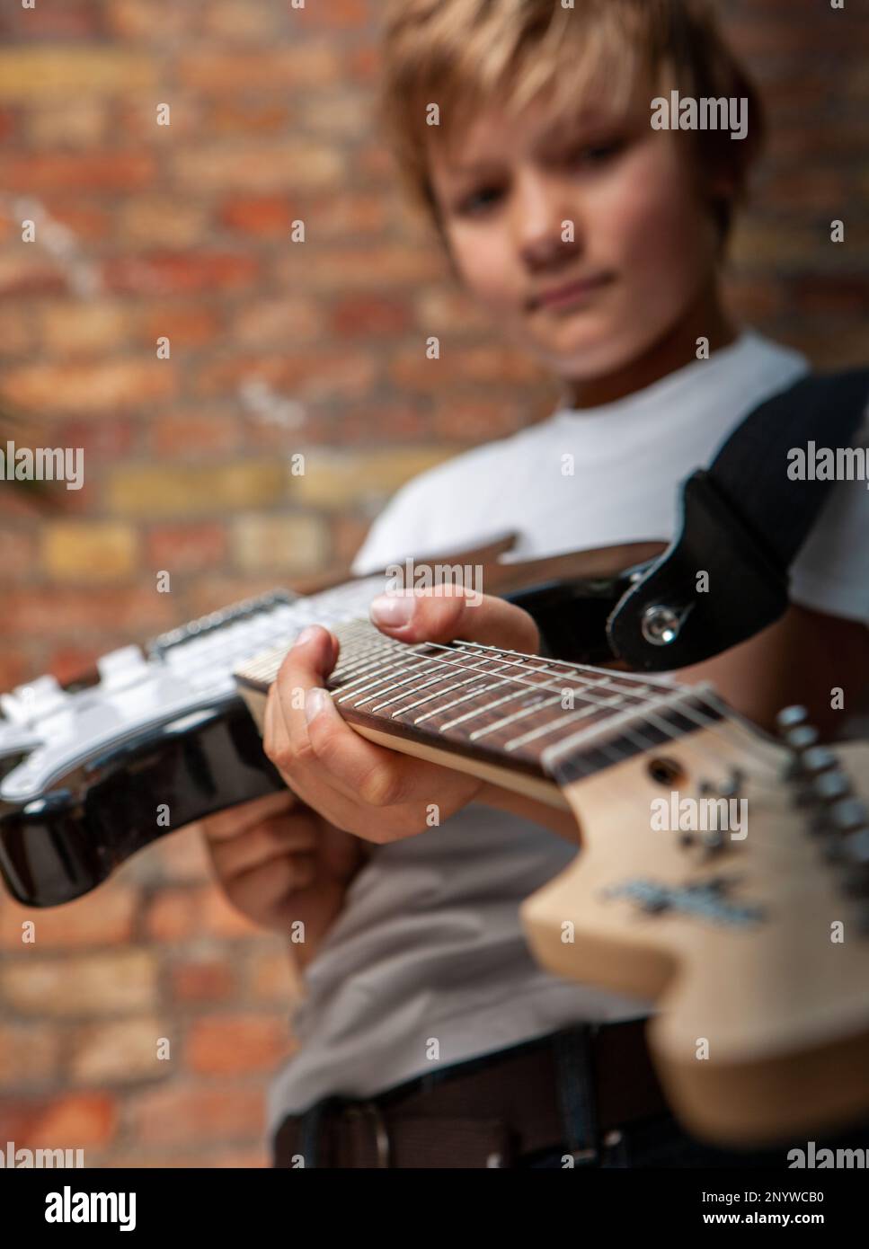 Family Life, Young Guitarist. An abstract angle along the neck of an ...