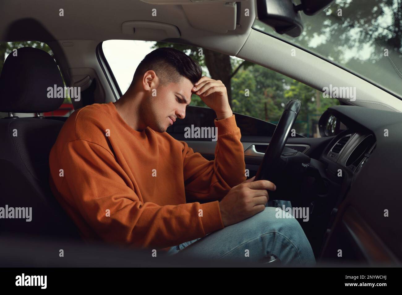Stressed man in driver's seat of modern car Stock Photo - Alamy