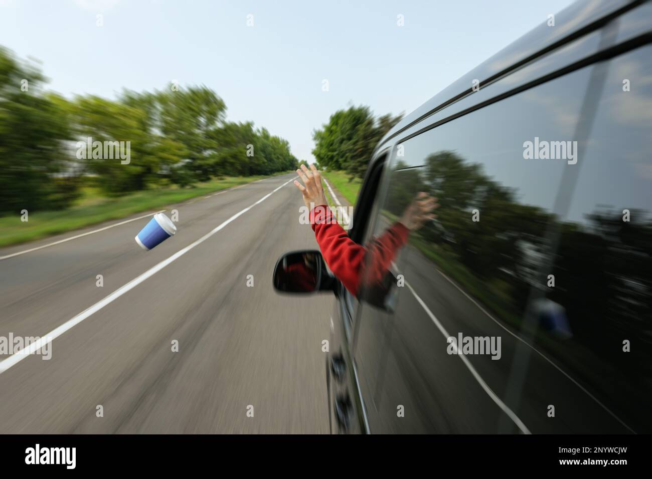 Driver throwing away paper coffee cup from car window. Garbage on road ...