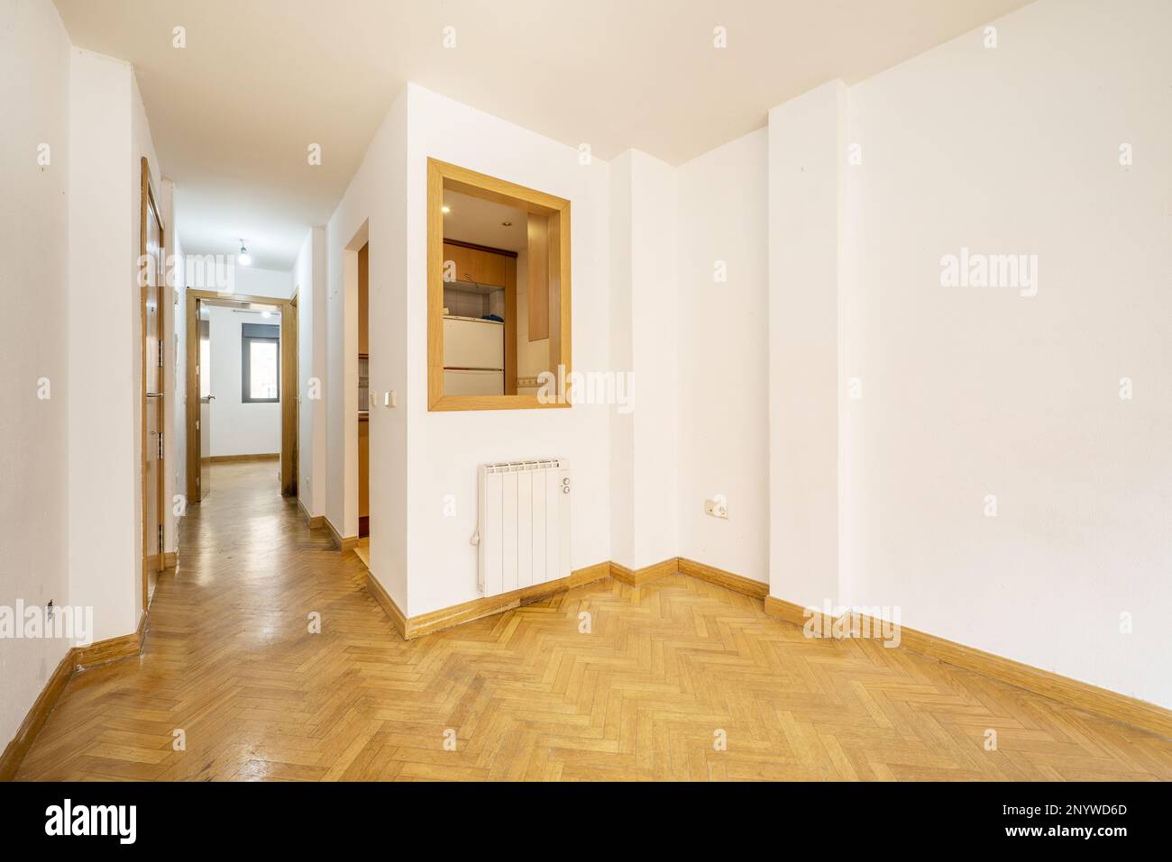 Living room of an empty apartment with a hatch window with an oak frame ...