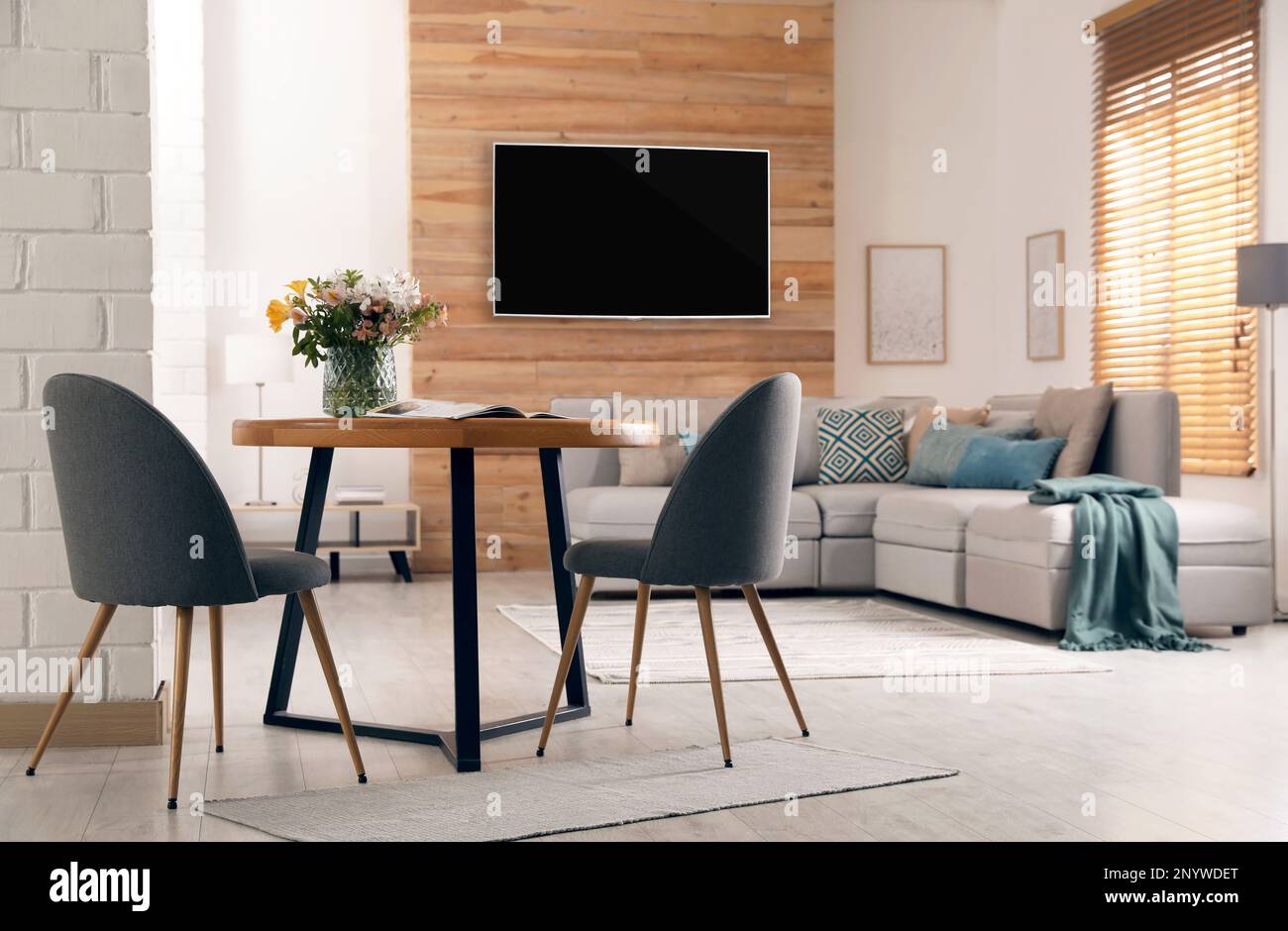 Modern wide screen TV on wall in room with stylish furniture Stock ...