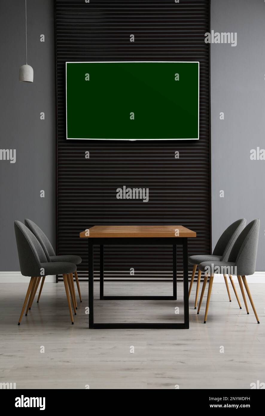 Modern wide screen TV on wall in room with stylish furniture Stock ...