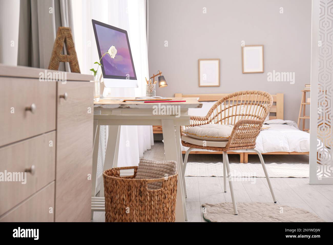 Comfortable workplace with modern computer near window in bedroom ...