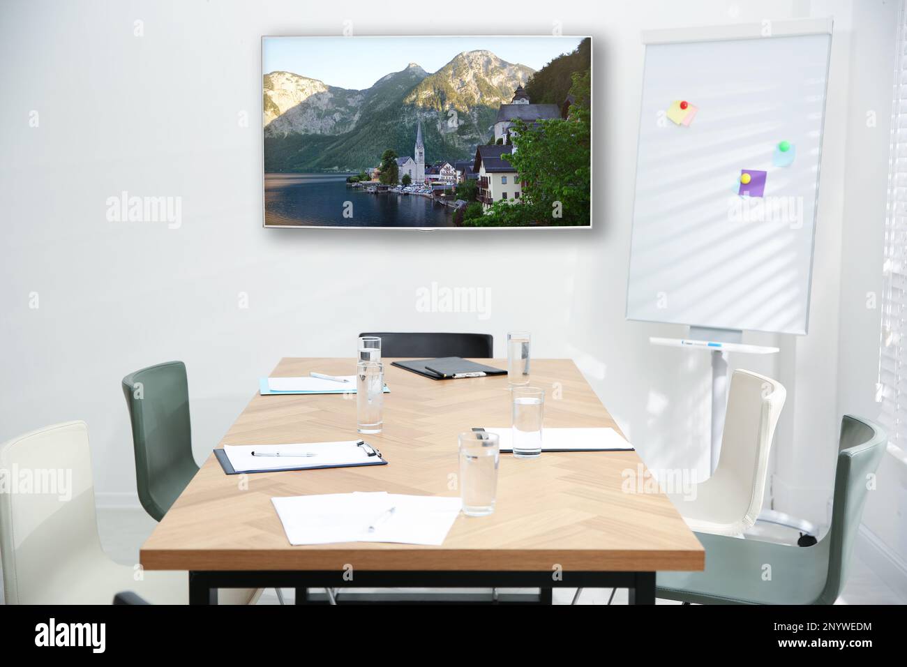 Modern wide screen TV on white wall in conference room Stock Photo - Alamy