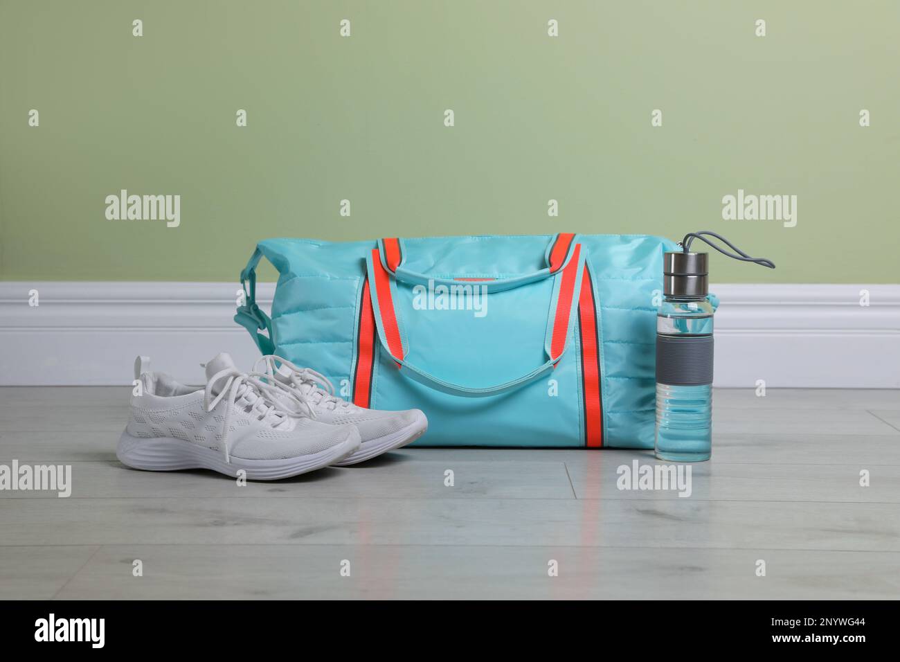 Bag with different sports equipment on wooden floor indoors Stock Photo ...