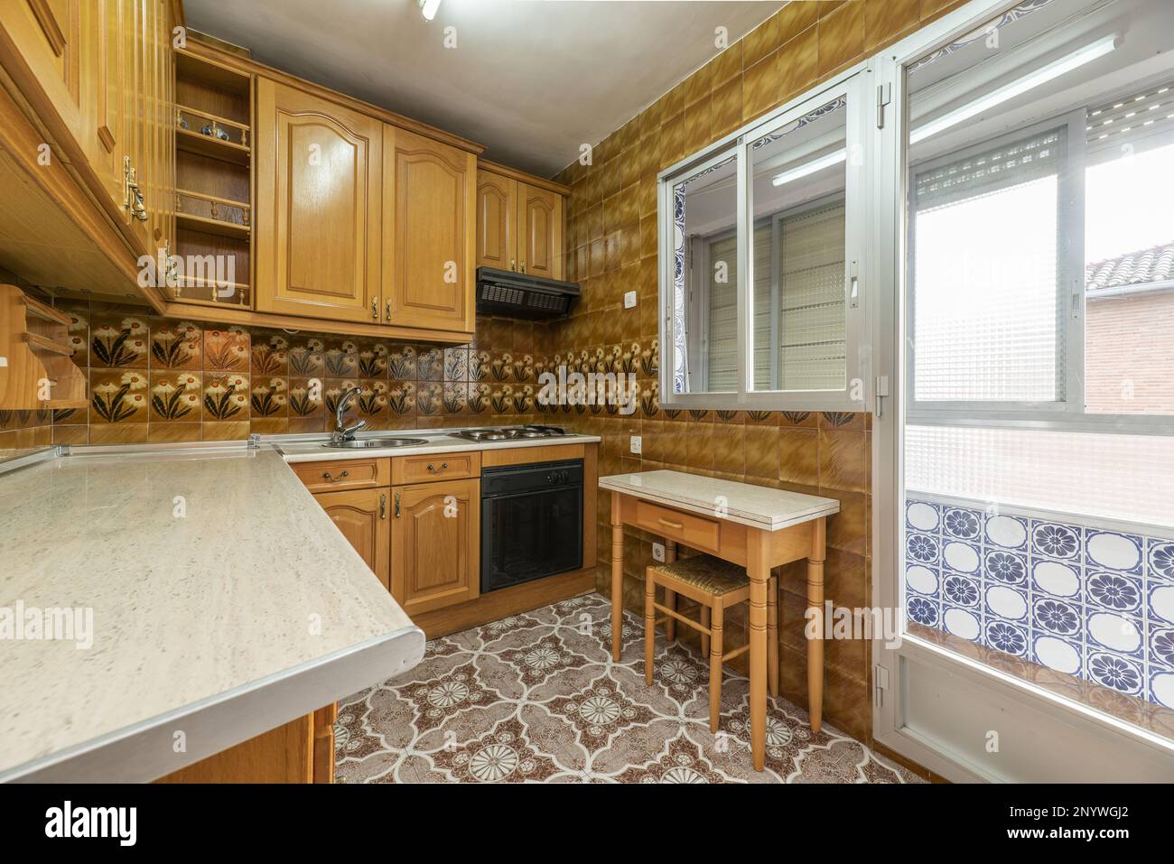 Kitchen furnished with Castilian-style wooden furniture, folding table ...