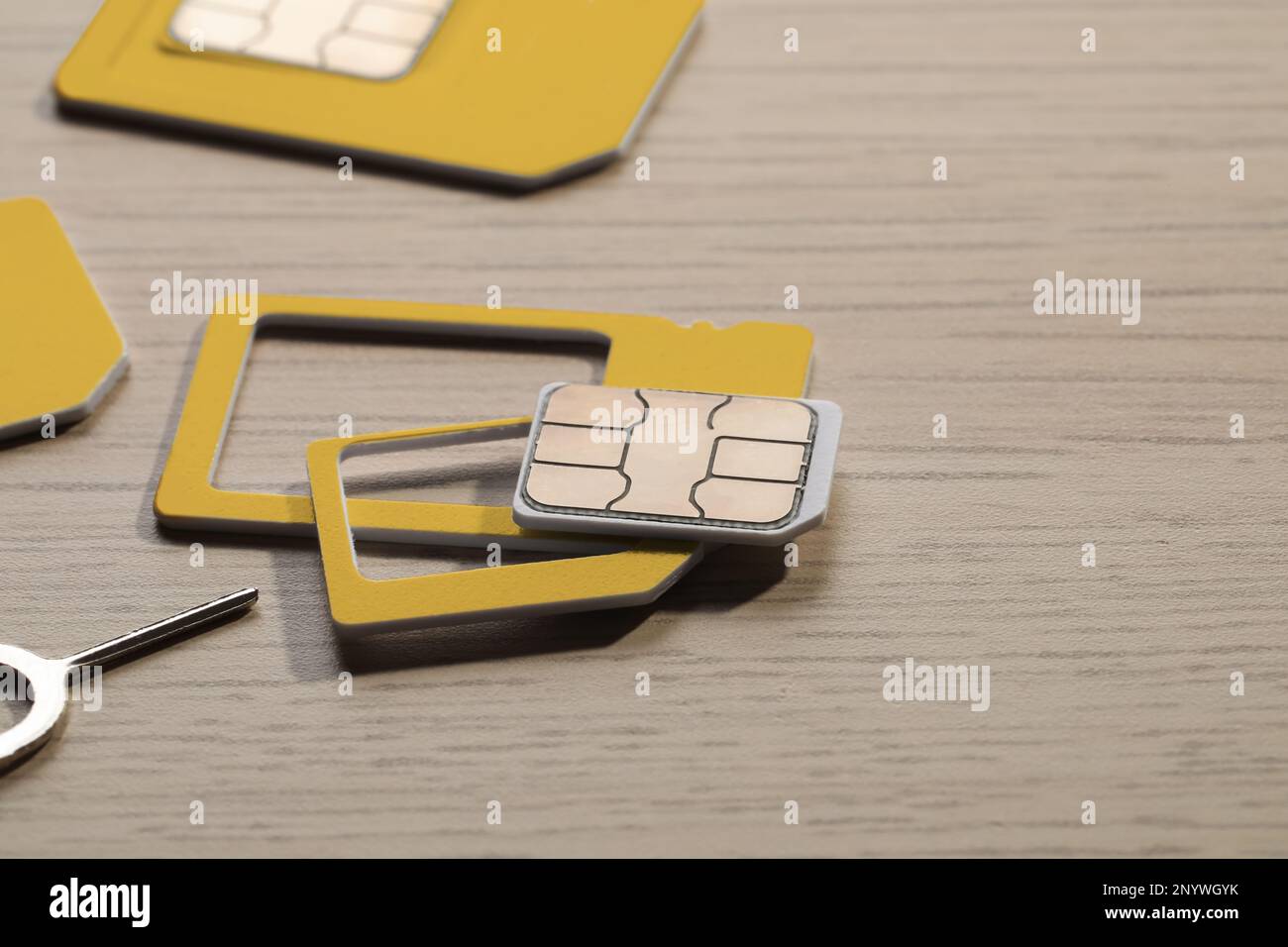 Different SIM cards and ejector on wooden background, closeup Stock ...